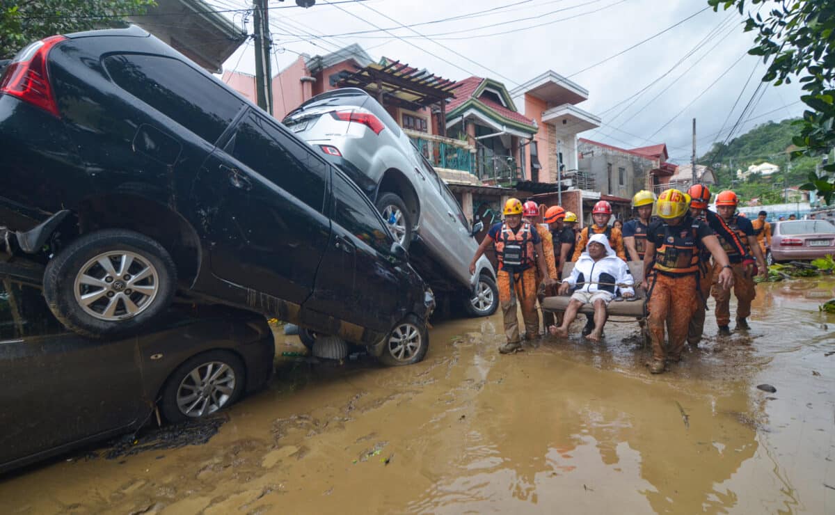 Tino floods leave cars in piles, trap families on rooftops